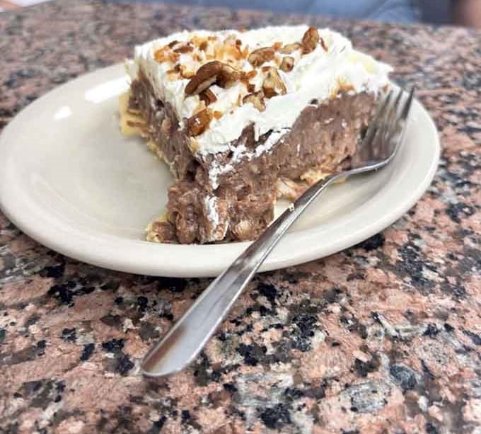 German chocolate pie with whipped cream and pecans is the kind of dessert that makes you reconsider your entire life plan.