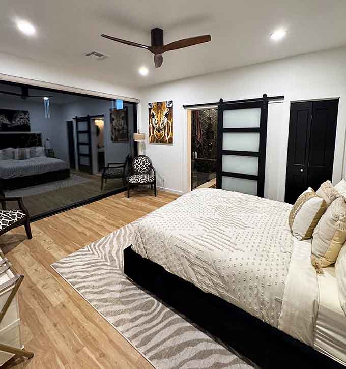 Modern barn doors and zebra-print accents create sleeping quarters where rustic charm shakes hands with contemporary style and actually gets along.