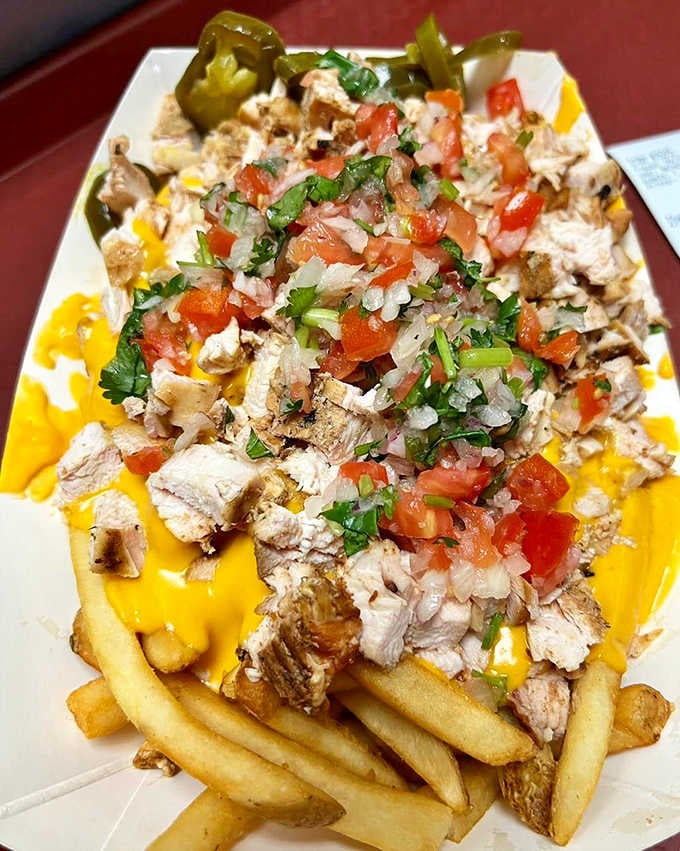 Loaded fries topped with chicken, cheese, and fresh pico transforms a simple side into dinner's main event.