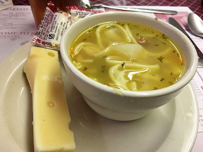 Homemade chicken noodle soup served with Swiss cheese, warming souls one spoonful at a time since forever.