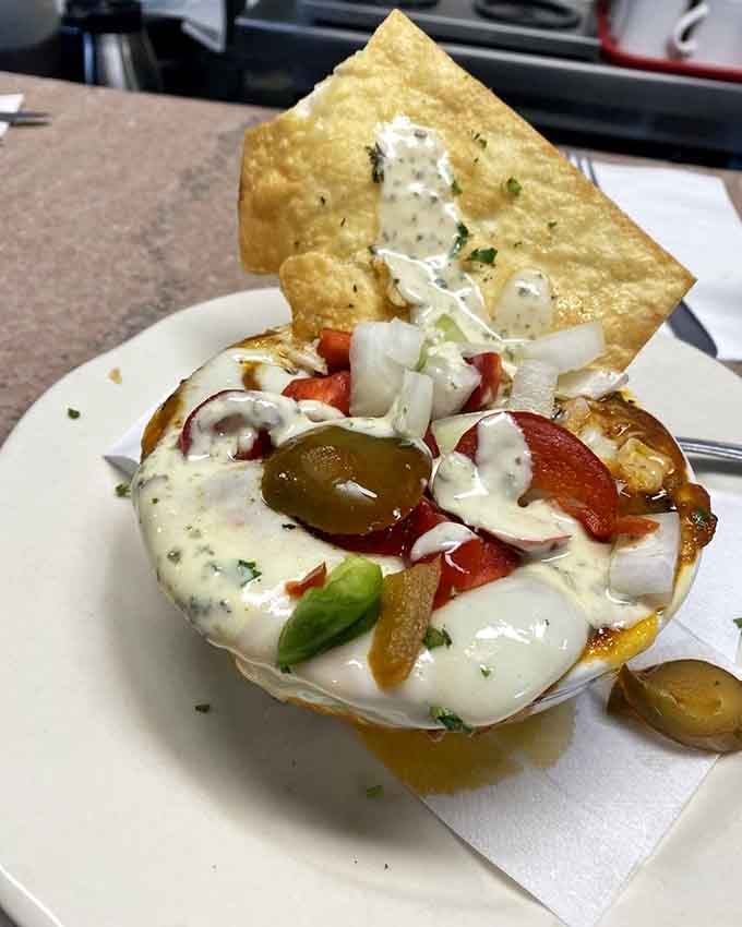 Chili served in a bread bowl with all the fixings, because sometimes you need your vessel to be edible too.