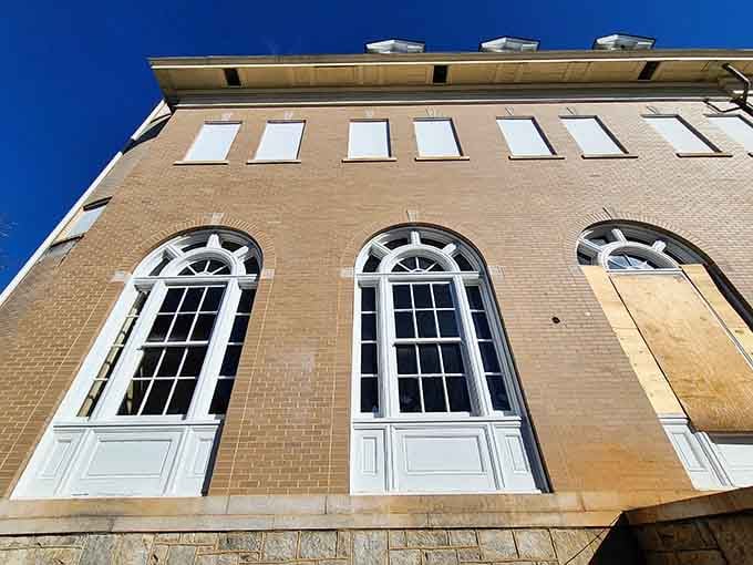Those arched windows against blue sky remind you that beauty persists even in abandonment's embrace.