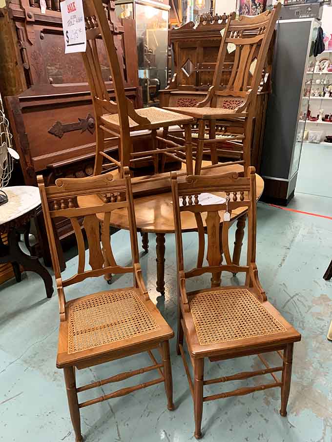 Cane-seated chairs stacked like old friends waiting for Sunday dinners, each one ready to host another century of family stories.