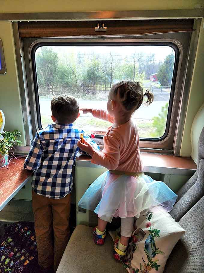 Two young passengers discover that the view from a train window beats any tablet screen.