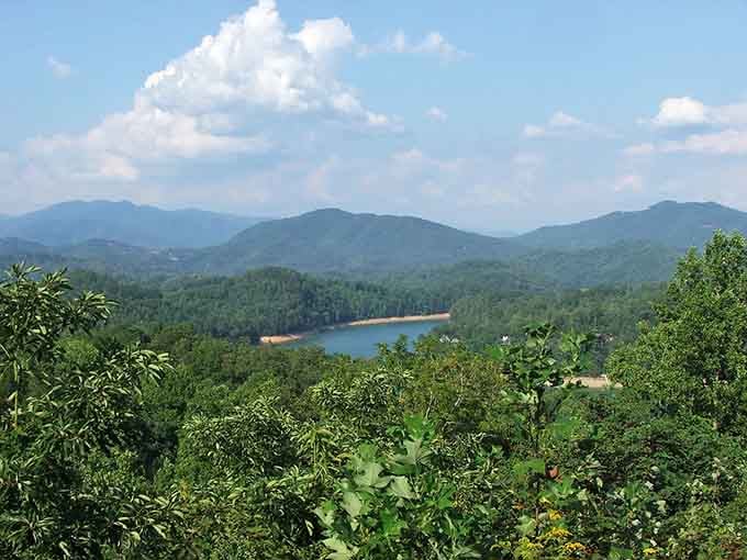 Mountain ridges roll toward the horizon while that blue reservoir winks at you from below like a sapphire someone dropped.