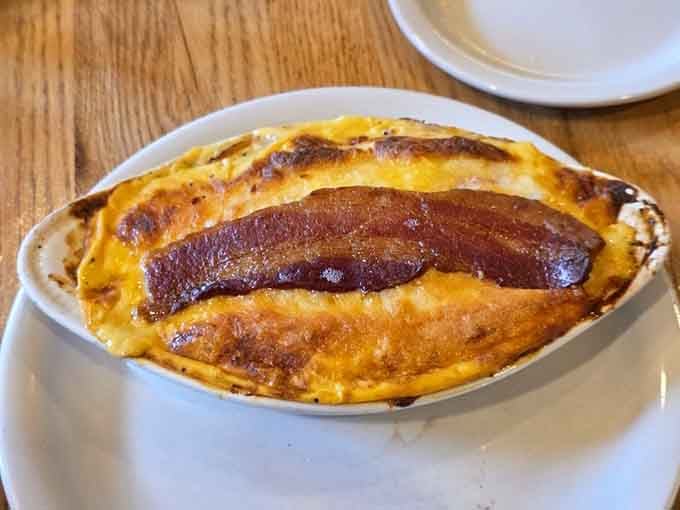 Kentucky Hot Brown with bacon standing tall like a delicious edible monument to comfort food excellence.