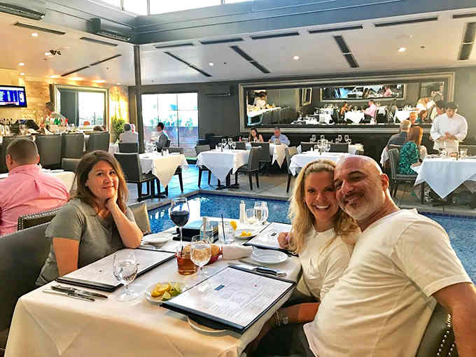 Happy diners enjoying their meal in the bright, airy upstairs space where good food meets even better company and conversation.