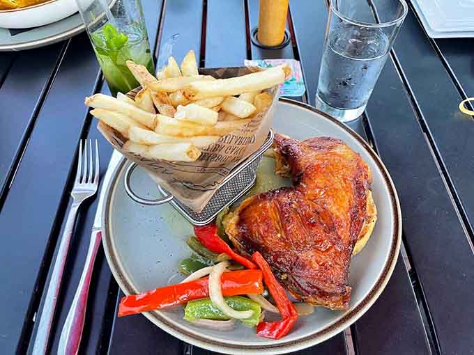 Golden roasted chicken with crispy skin and a basket of fries delivers simple pleasures executed to perfection.