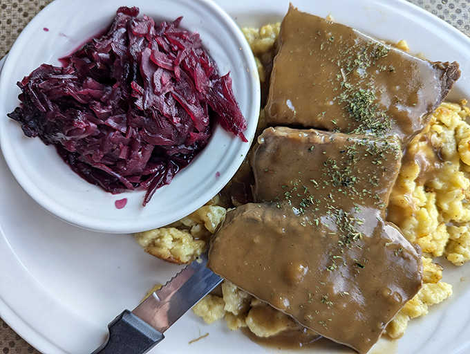 Sauerbraten smothered in rich gravy alongside red cabbage and sp&auml;tzle is comfort food with a German accent.
