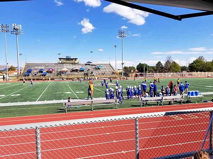 Friday night lights still matter here, where high school football brings the whole community together under one sky.