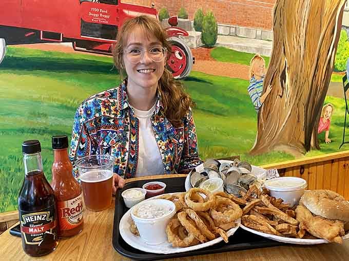 Pure joy captured in one frame: golden fried perfection and that magnificent mural transporting you lakeside.