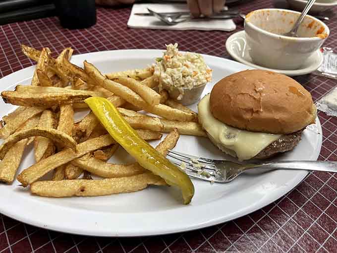 A proper burger with fries and coleslaw, the kind of lunch that reminds you why simple done right beats fancy every time.