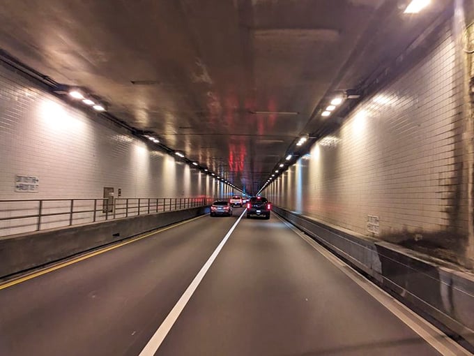 White-tiled walls stretch endlessly ahead, creating an almost meditative experience if you ignore the semi-trucks beside you.