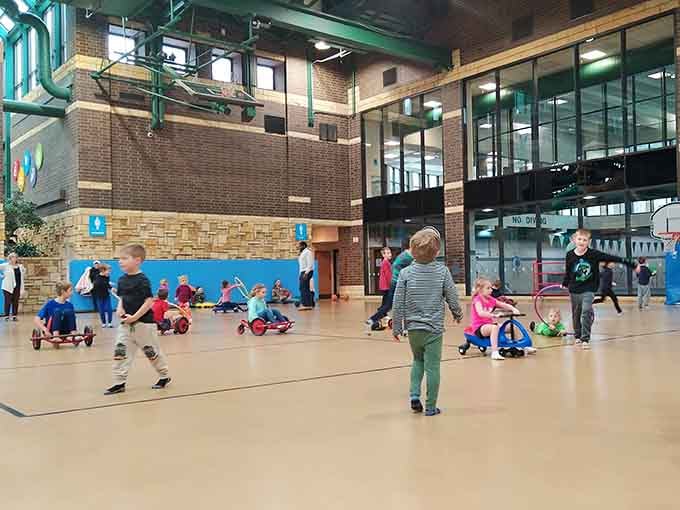 Kids on ride-on toys cruise the gym floor like tiny commuters, except their traffic jams are actually adorable.