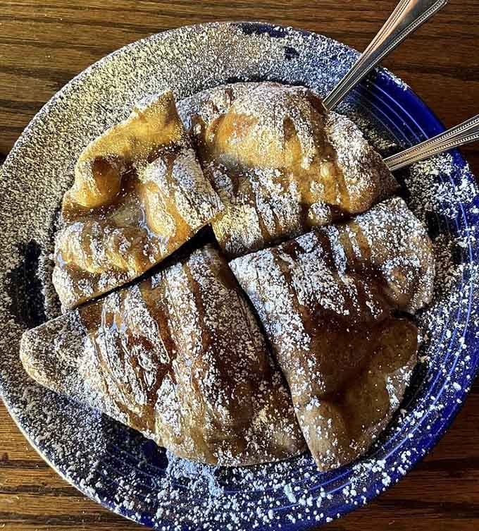 Sopapillas dusted with enough powdered sugar to make every diet resolution seem like a distant, irrelevant memory.
