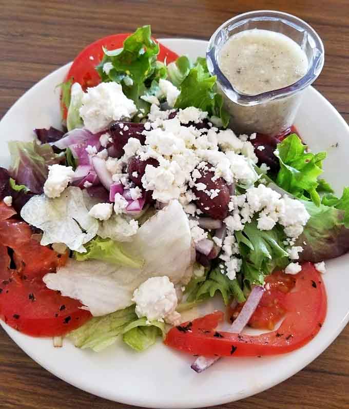 Fresh vegetables, crumbled feta, and sliced tomatoes make this salad a colorful departure from the usual greens.