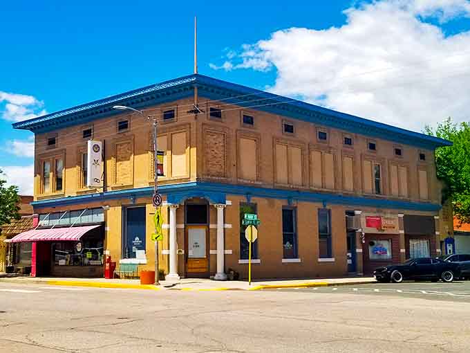 That bold yellow corner building with blue trim shows how a little paint can make historic architecture pop like a Wes Anderson film set.