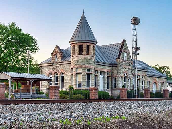 The old train depot's Romanesque Revival architecture makes modern buildings look like they gave up halfway through.