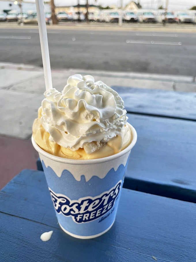 That cloud of whipped cream towers over banana-infused soft-serve like a sweet, billowy crown of pure dairy joy.