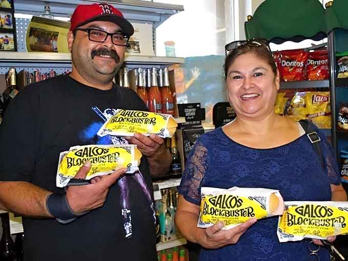 Happy customers holding their Blockbuster sandwiches like proud parents, and honestly, who could blame them for the enthusiasm?