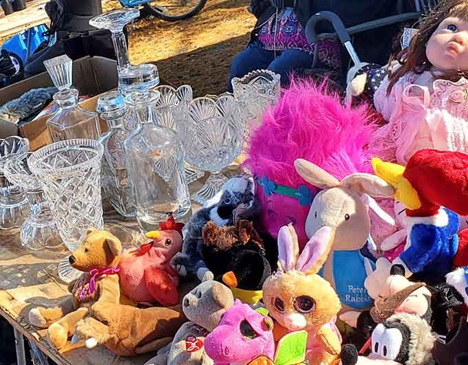 Plush toys and crystal glassware share table space in delightful chaos, proving that stuffed animals and fine china can coexist.