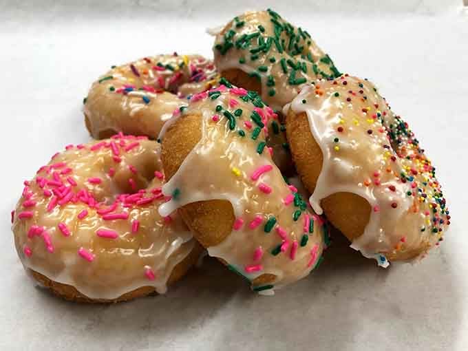 Glazed donuts wearing their sprinkle outfits like they're headed to the world's most delicious party ever thrown.