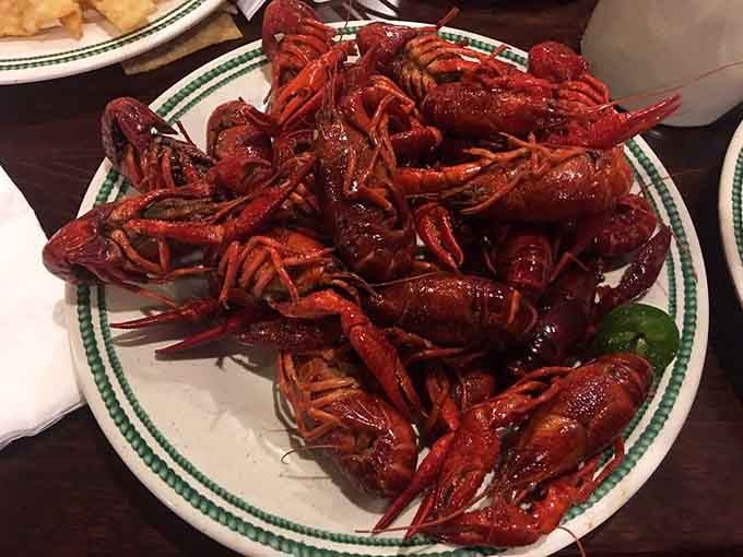 Crawfish piled high like edible treasure, ready to reward your patience with sweet, succulent meat inside.
