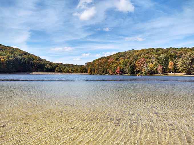 That crystal-clear shallow water reveals every ripple in the sand, making you wonder why you've been tolerating murky lakes elsewhere.