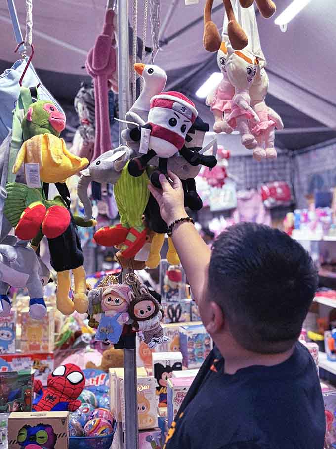 Plush toys dangling overhead like a carnival prize wall, tempting kids and nostalgic adults with equal effectiveness.