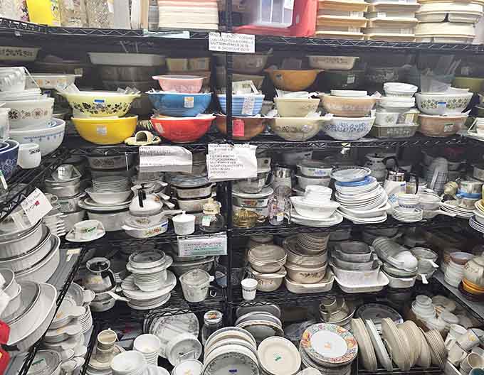 Stacks of vintage dinnerware in every color imaginable, like a rainbow made of ceramic and memories.