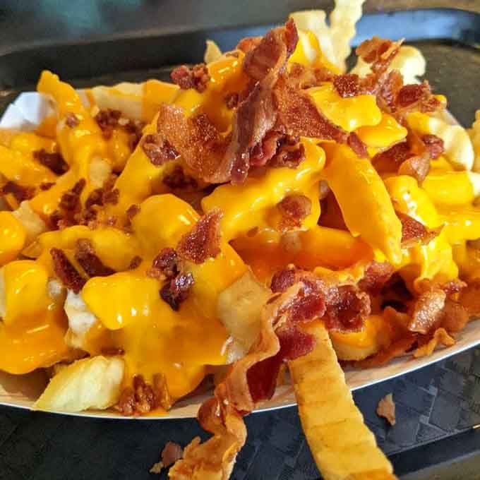 Fries come loaded with bacon and cheese, turning side dish into main event.