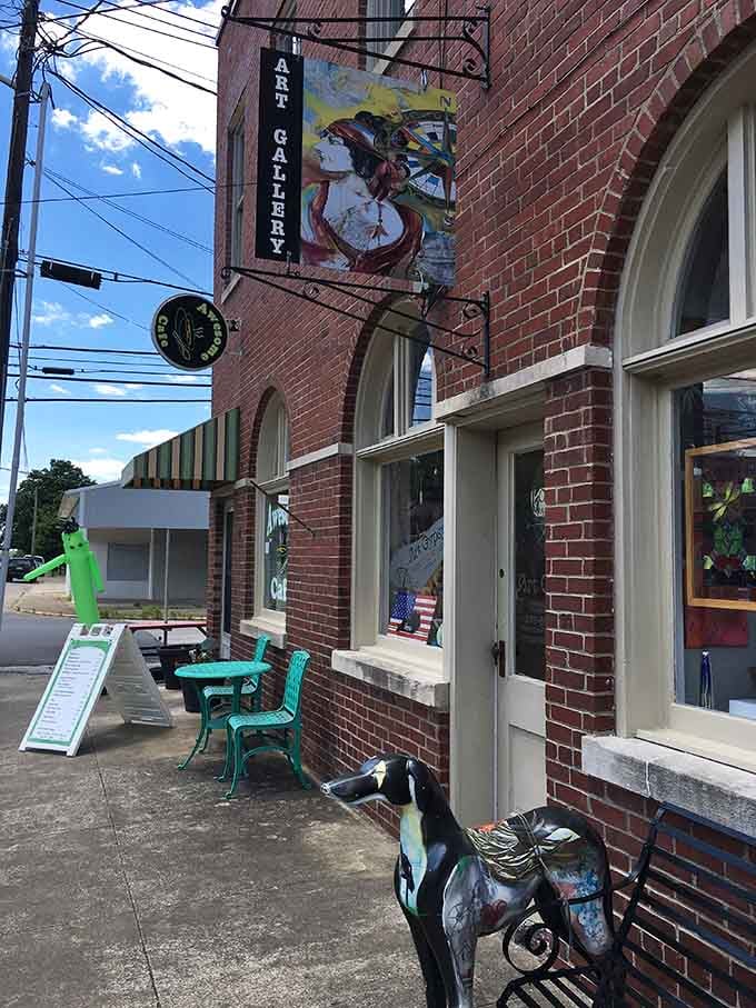 That colorful art gallery sign and whimsical painted horse sculpture add unexpected creative flair to this charming brick streetscape.