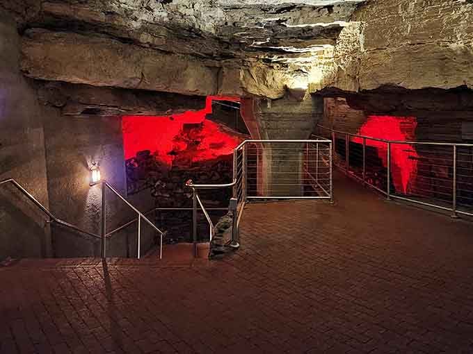Red lighting transforms ancient rock into something resembling a very exclusive underground nightclub without the velvet rope.