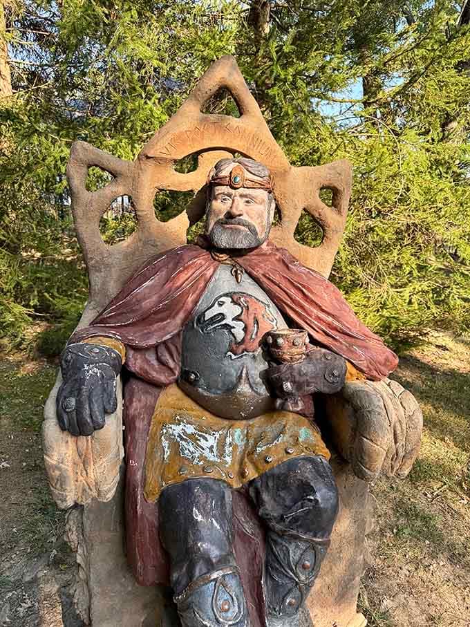 This regal king sits upon his throne, complete with ornate details that would make any medieval monarch jealous of his concrete kingdom.