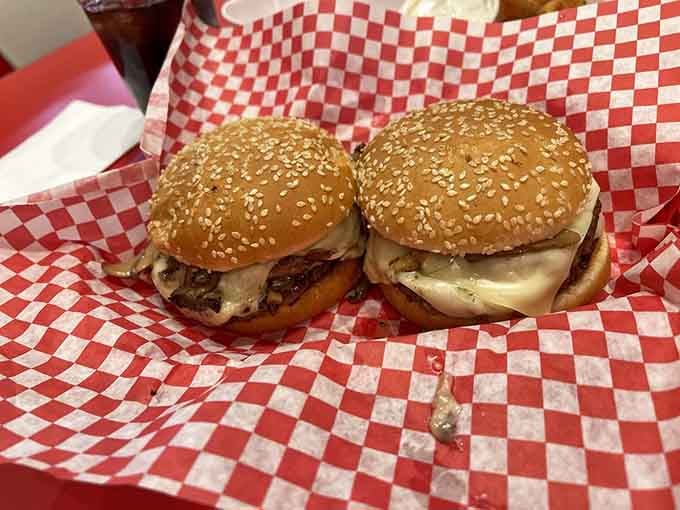 Two Mushroom Swiss Burgers on sesame buns, sitting there like they're posing for their high school yearbook photo.