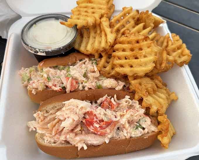 Lobster rolls piled high enough to require architectural support and possibly a construction permit.