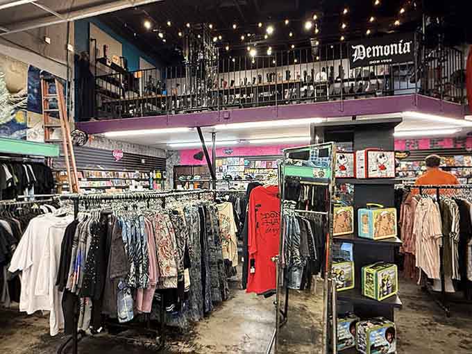 Clothing racks stretch toward that elevated platform like a fashion runway designed by Tim Burton's cheerful cousin.