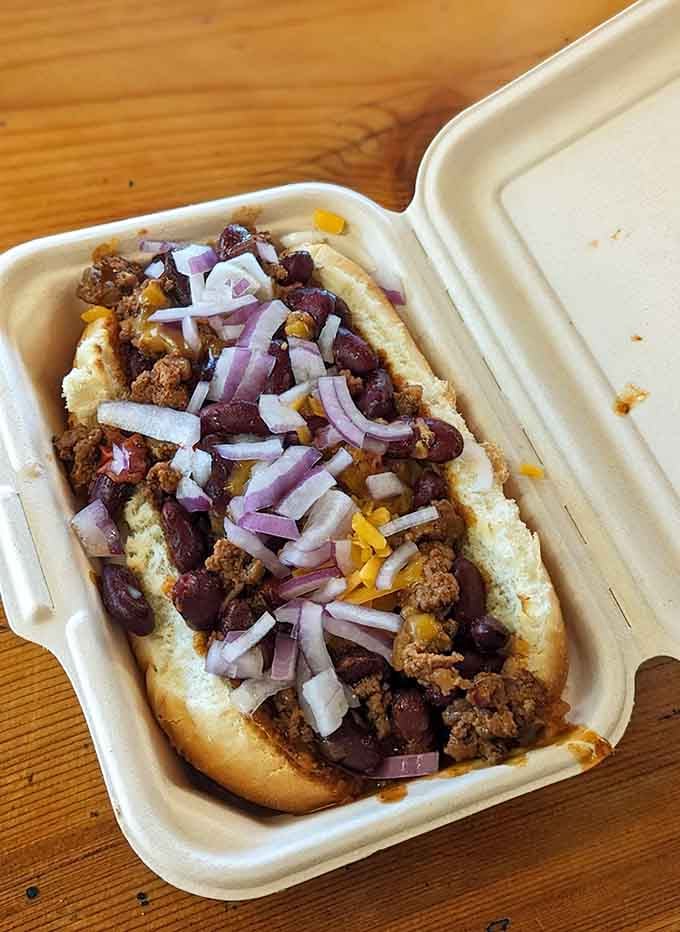 Chili cheese dog loaded with beans, meat, cheese, and onions, basically a complete meal in bun form.