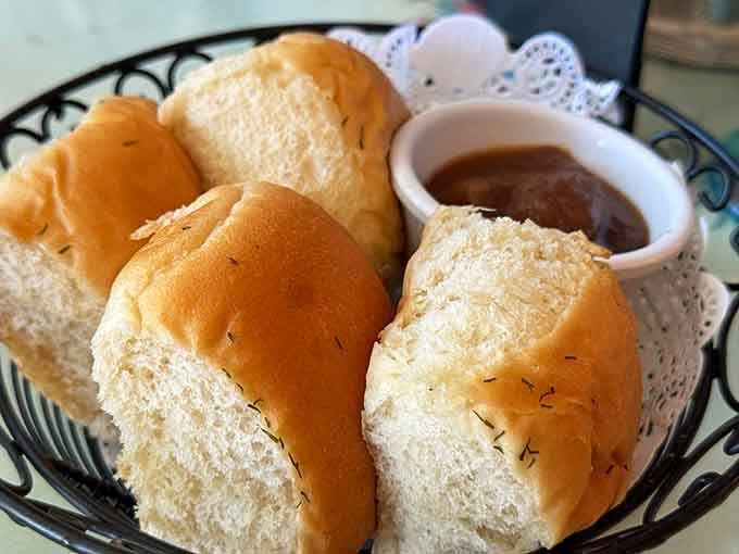 Fresh rolls with herb butter, proving that bread baskets can absolutely steal the show from entrees.