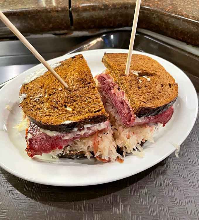 Corned beef, sauerkraut, and melted cheese on rye, because some sandwiches are worth the inevitable food coma.