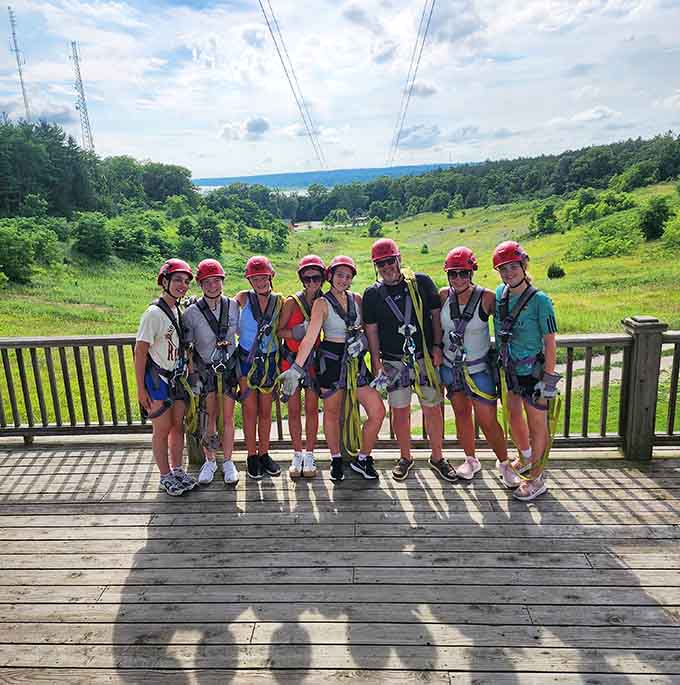 Squad goals achieved at the scenic overlook, all geared up and grinning before launching into adventure.