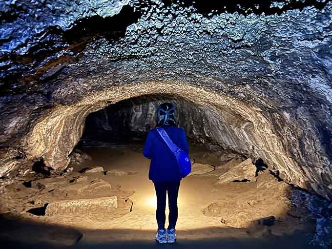 One explorer, one headlamp, and thousands of years of geological history stretching into the darkness ahead.