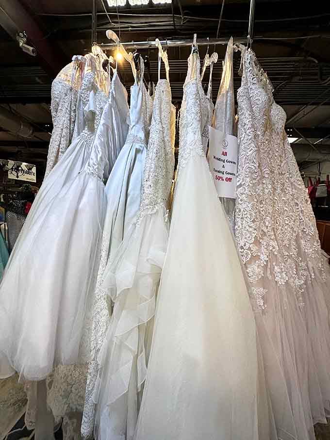 Wedding gowns hanging like elegant ghosts of celebrations past, ready for their second trip down the aisle.