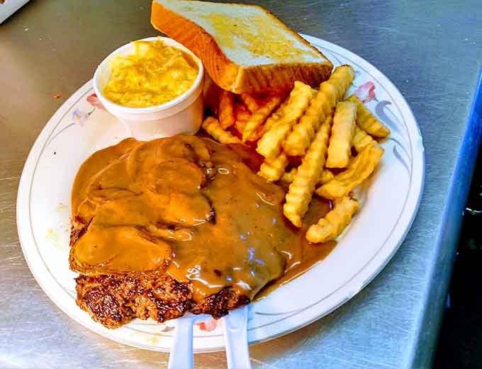 The hamburger steak swims in gravy like it's found its true calling, comfort food at its most unapologetic.