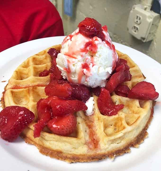 Fresh waffles topped with strawberries and ice cream: breakfast rules don't apply when you're on vacation mode.