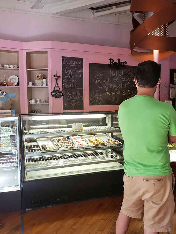 The universal stance of someone making impossible decisions while staring at too many delicious options.