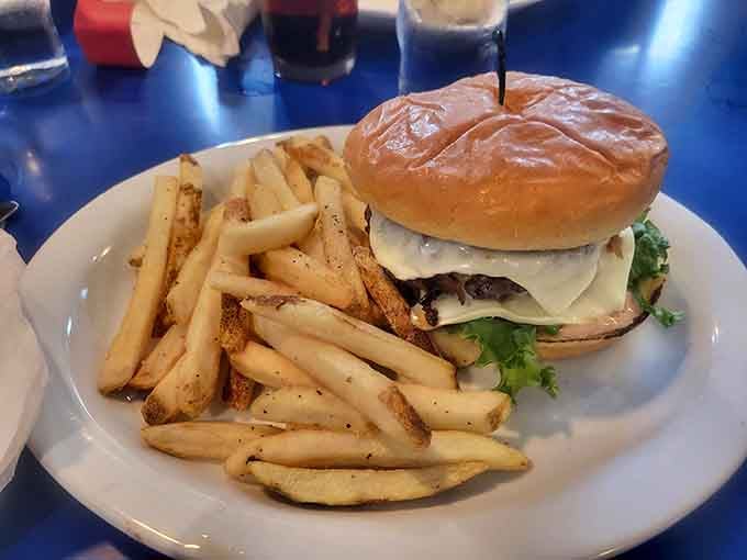 A classic burger with fries demonstrates that sometimes the simplest dishes are the most satisfying choices available.