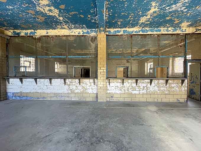 The old commissary area shows its age beautifully: peeling blue ceiling paint creates an accidentally artistic backdrop for institutional memories.