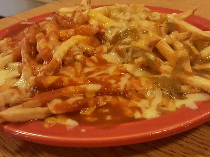 Chili cheese fries that understand the assignment, loaded with enough toppings to require strategic planning before eating.