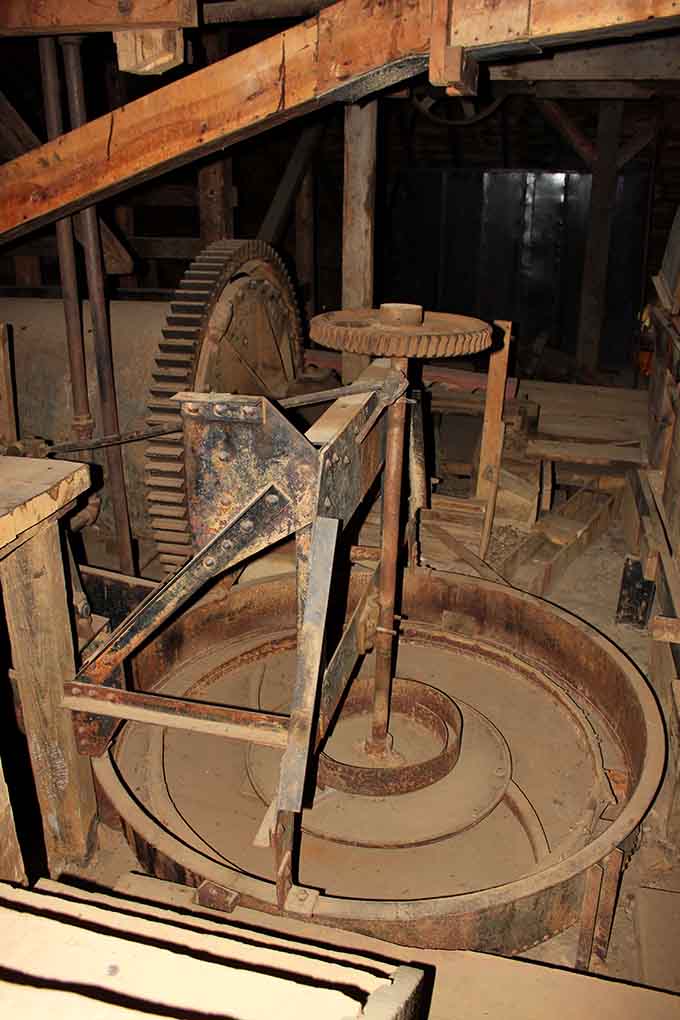 The grinding pan's circular design speaks to an era when engineering meant problem-solving, not computer screens.